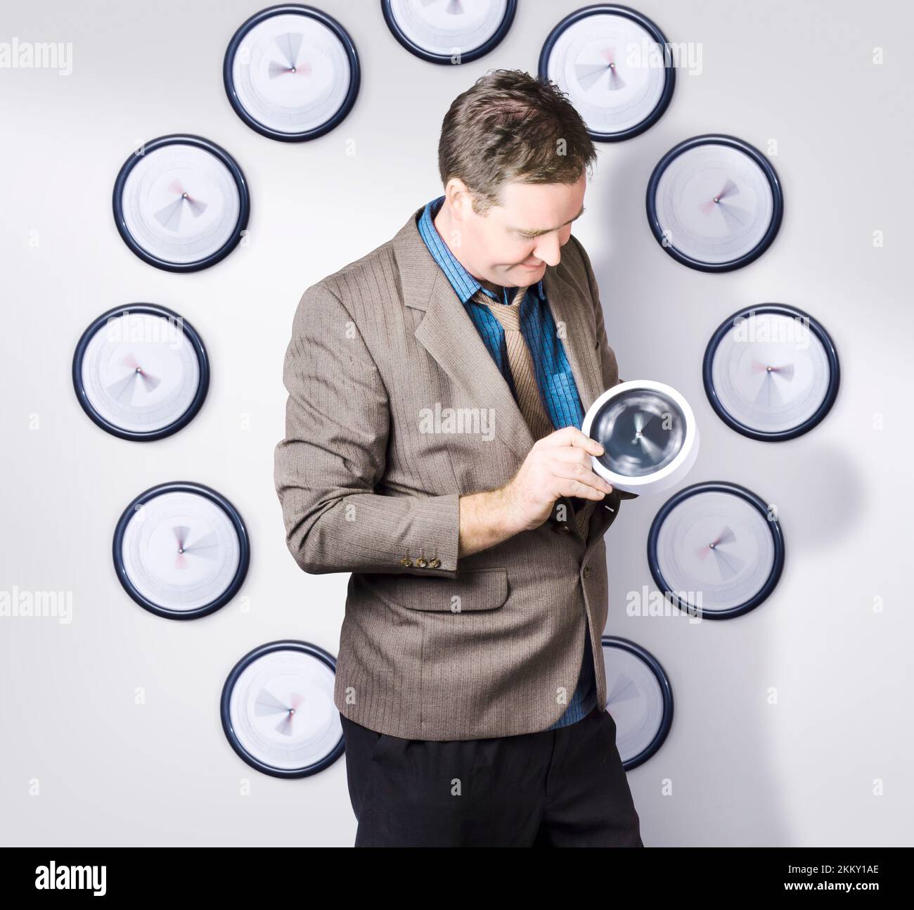 Time management business man looking at hours on spinning clock ...