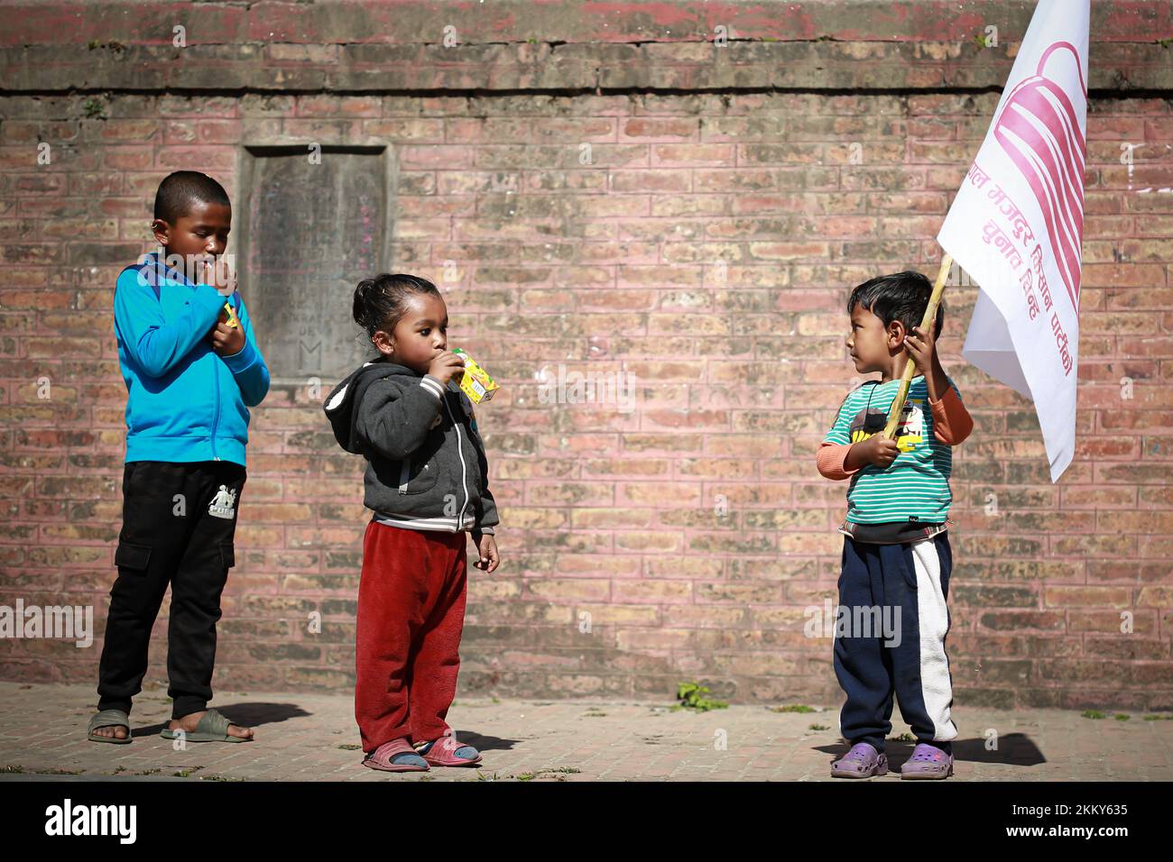 Nepal. 26th Nov, 2022. Children carries the flag of Nepal Workers and ...