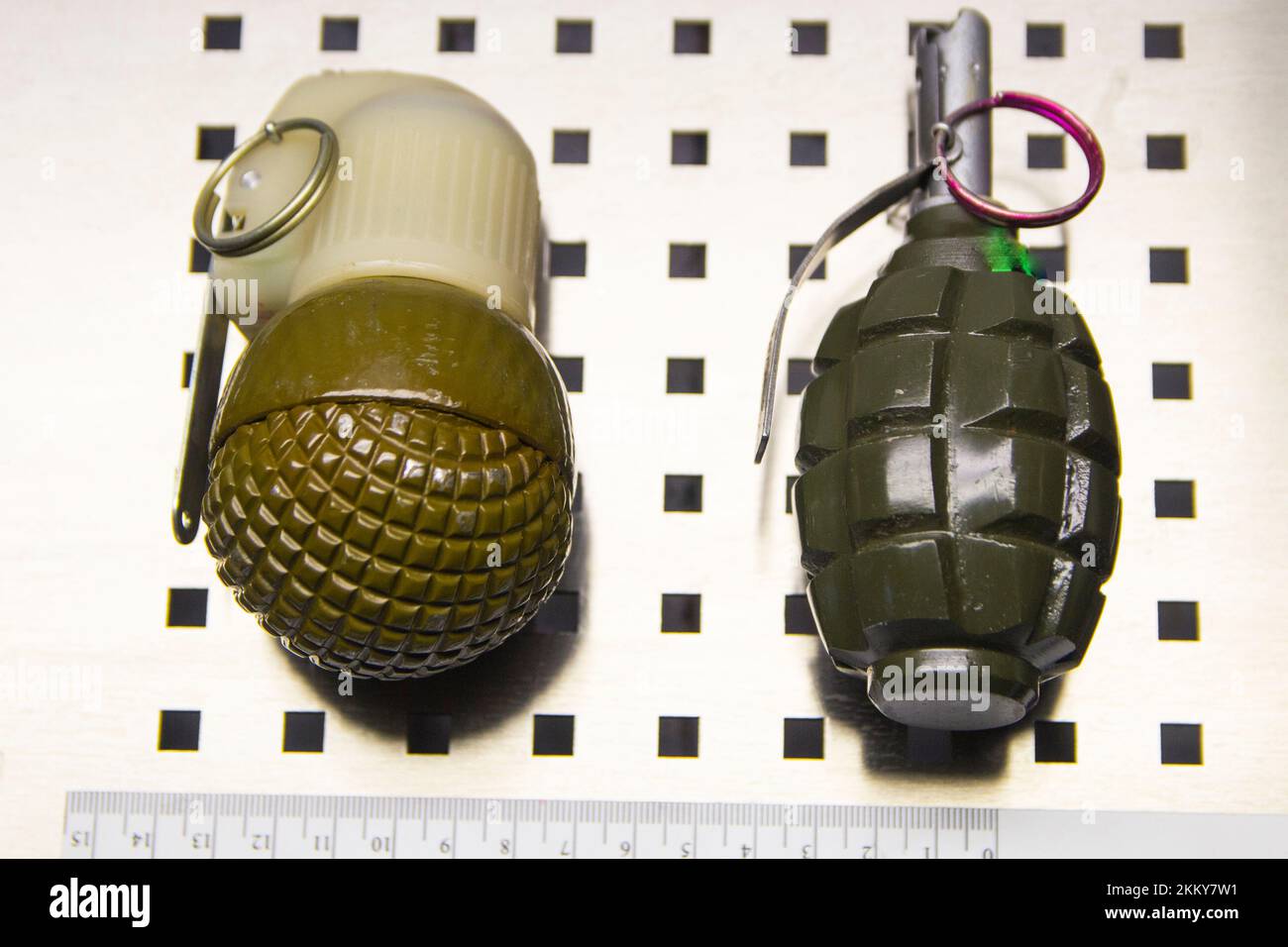 two hand-held fragmentation metal grenades with a forensic ruler Stock ...