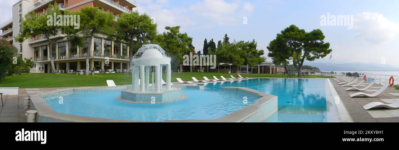Blue water swimming pool at a hotel by the Saronic Gulf, early morning ...