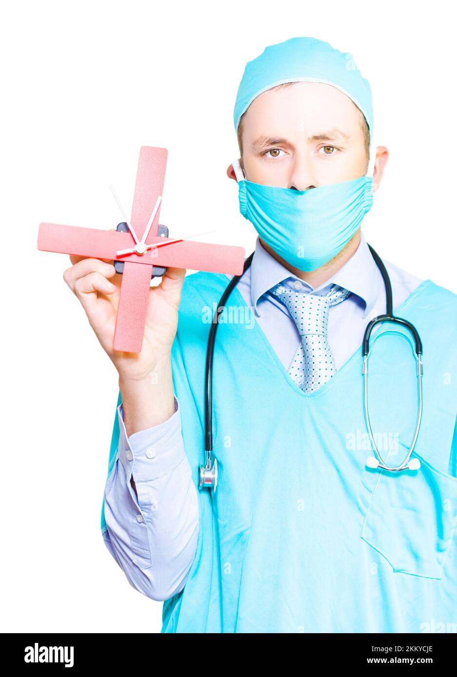 A male doctor in a gown and mask with a stethoscope around his neck ...