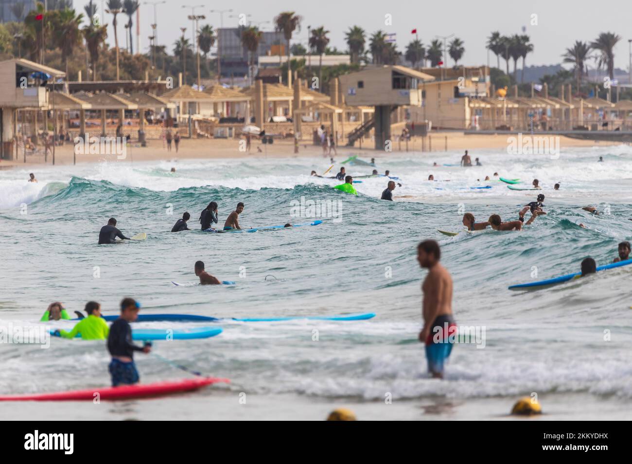Israel, Haifa 05, 2022: A large number of surfers on the beach in the ...