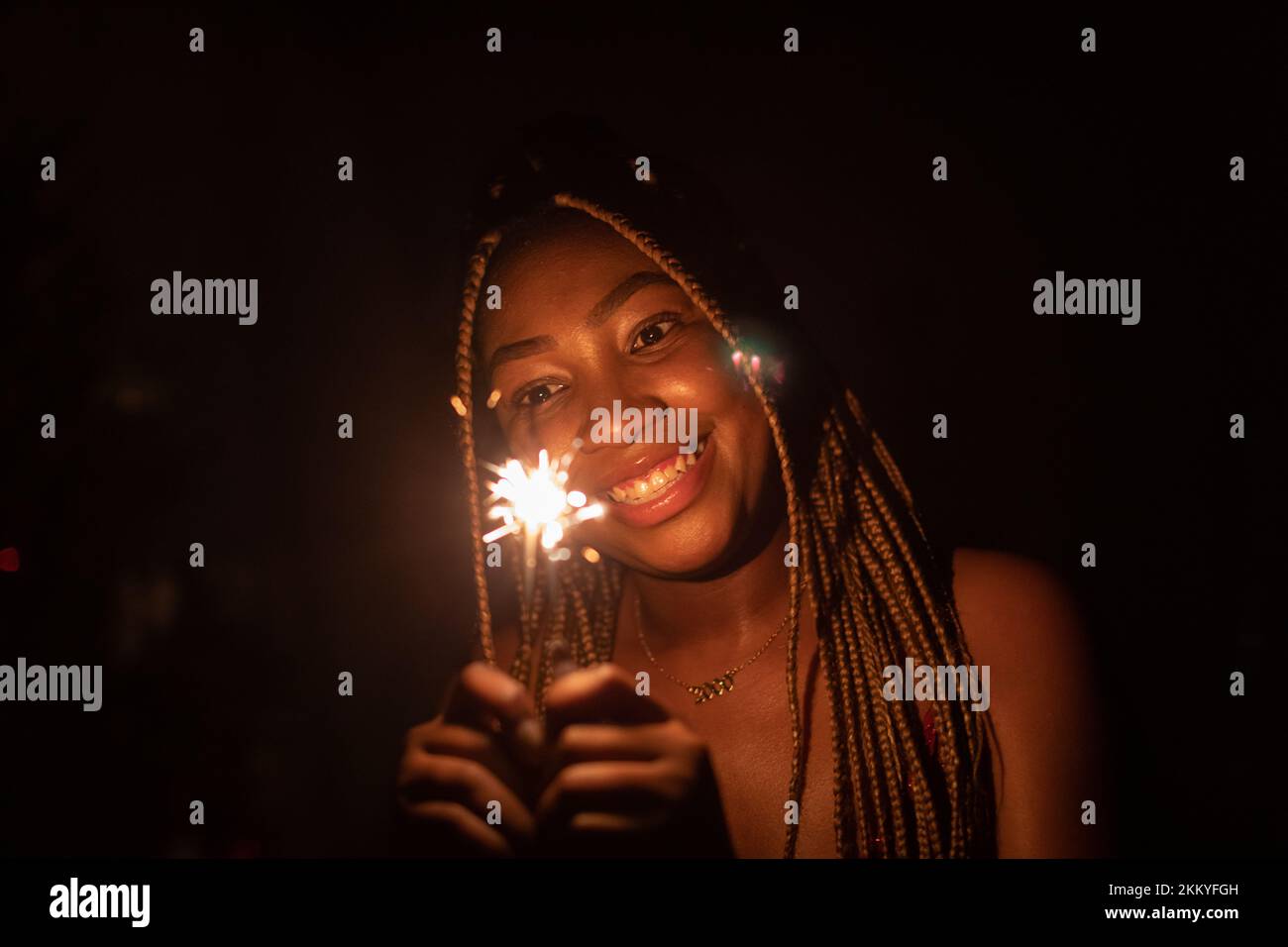 An Attractive Dark Skinned Girl Holds Burning Cold Fires In Her Hand