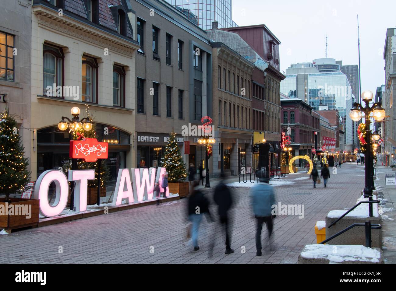 During the holiday season, people, blurred, walk down the popular ...