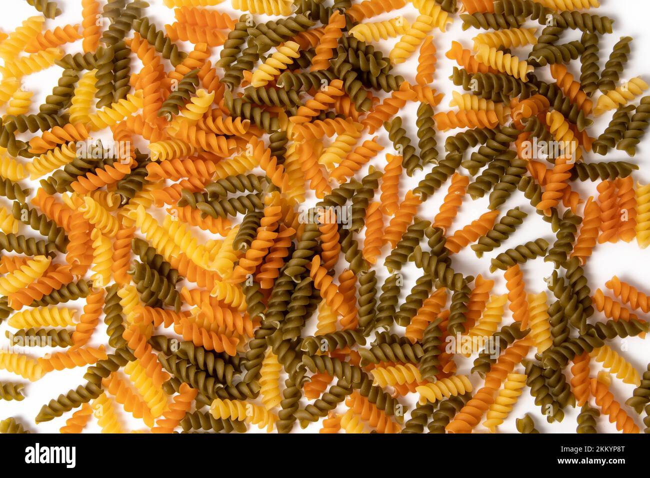 Fusilli pasta in three colors on white background Stock Photo - Alamy