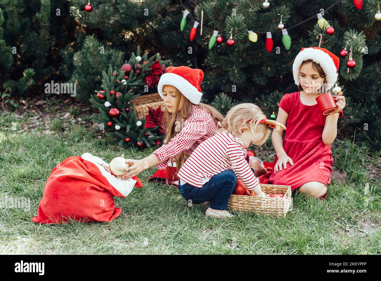 Merry Christmas. Portrait of three funny children girls in Santa hat ...