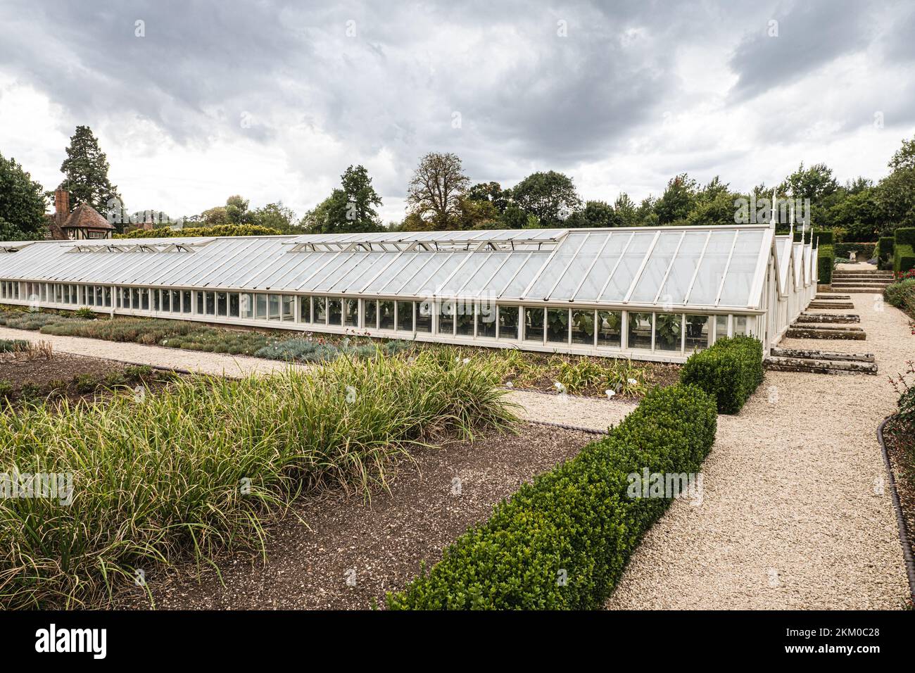 The elegant Victorian greenhouses under cloudy sky at Eythrope Gardens ...