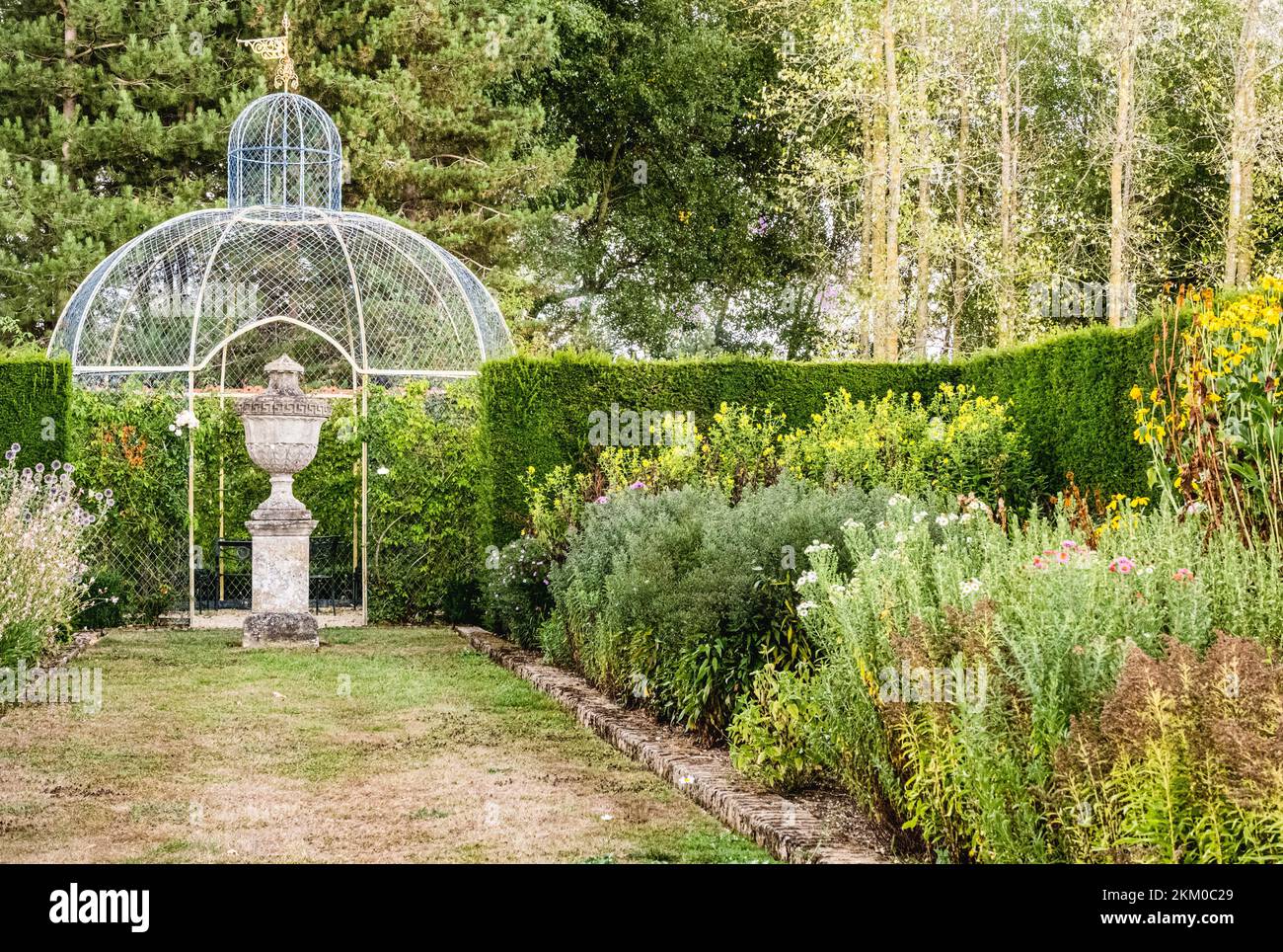 A wire pagoda at the end of one of the flower beds at Eythrope Gardens ...