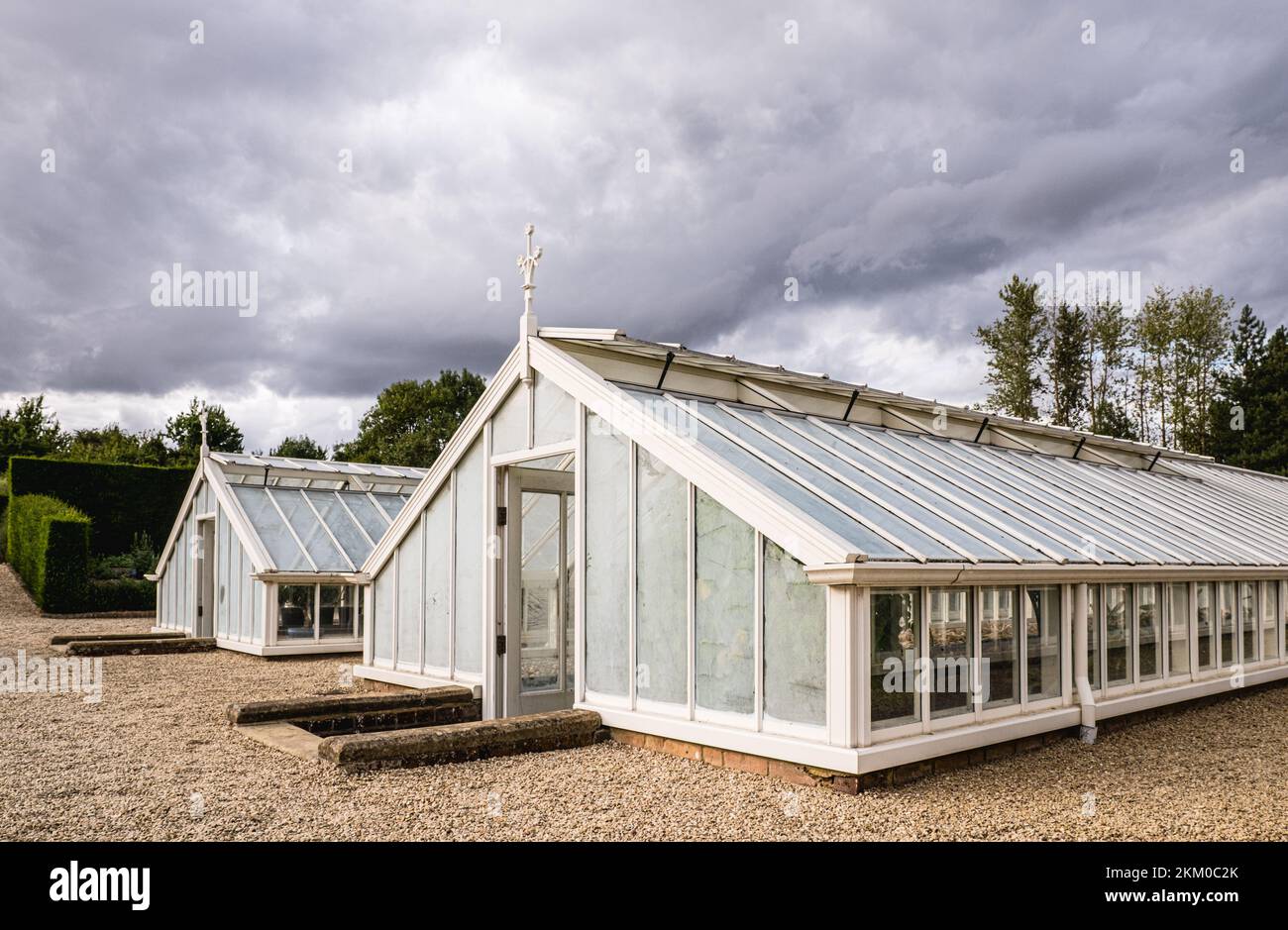 The elegant Victorian greenhouses under cloudy sky at Eythrope Gardens ...