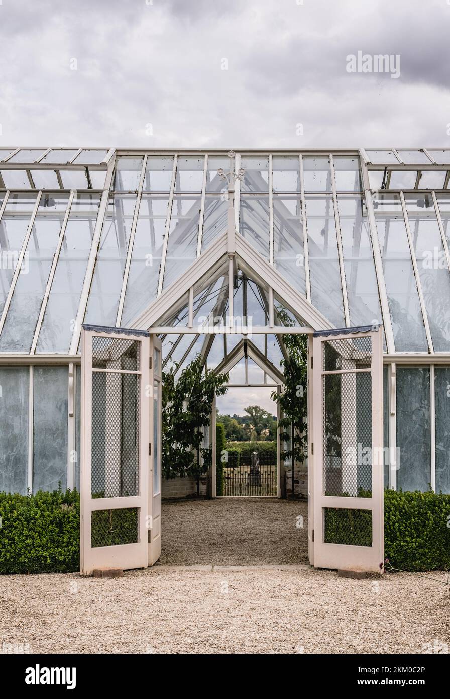 A vertical shot of the elegant Victorian greenhouse at Eythrope Gardens ...