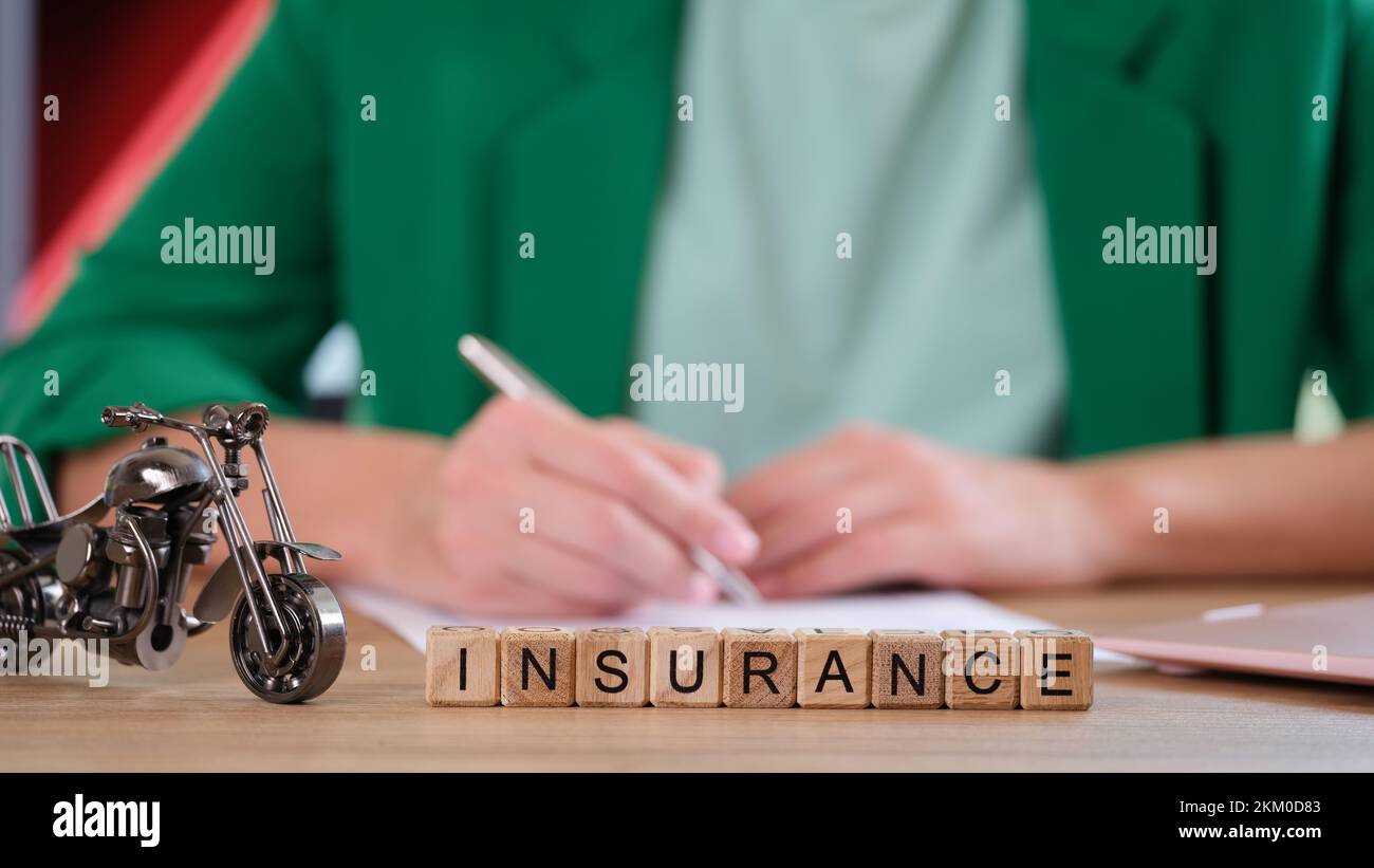Insurance word on wooden cubes in row, insurance broker on background ...