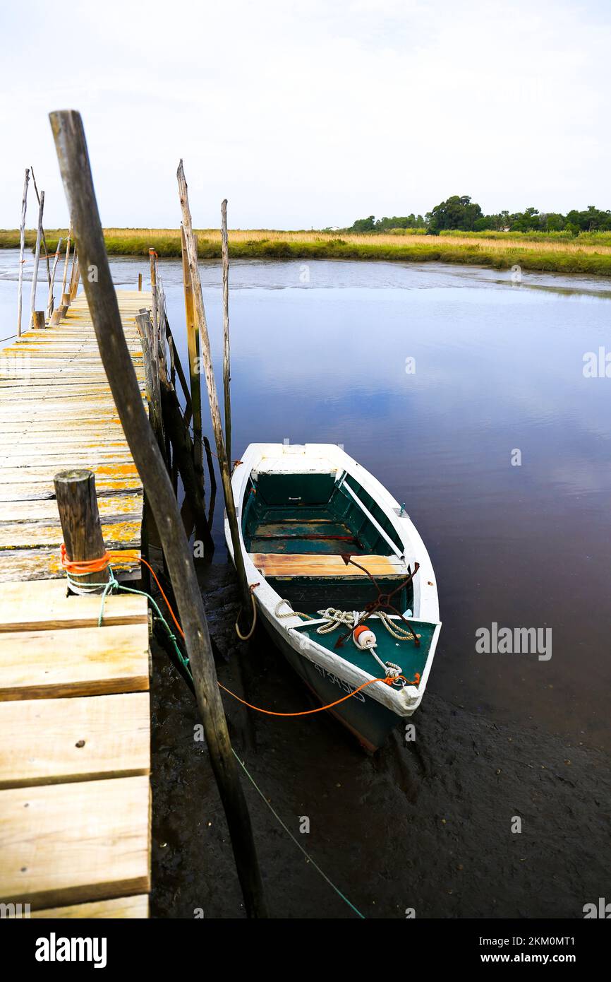 Fishing boat docked in a port with wooden walkway in Carrasqueira Stock ...