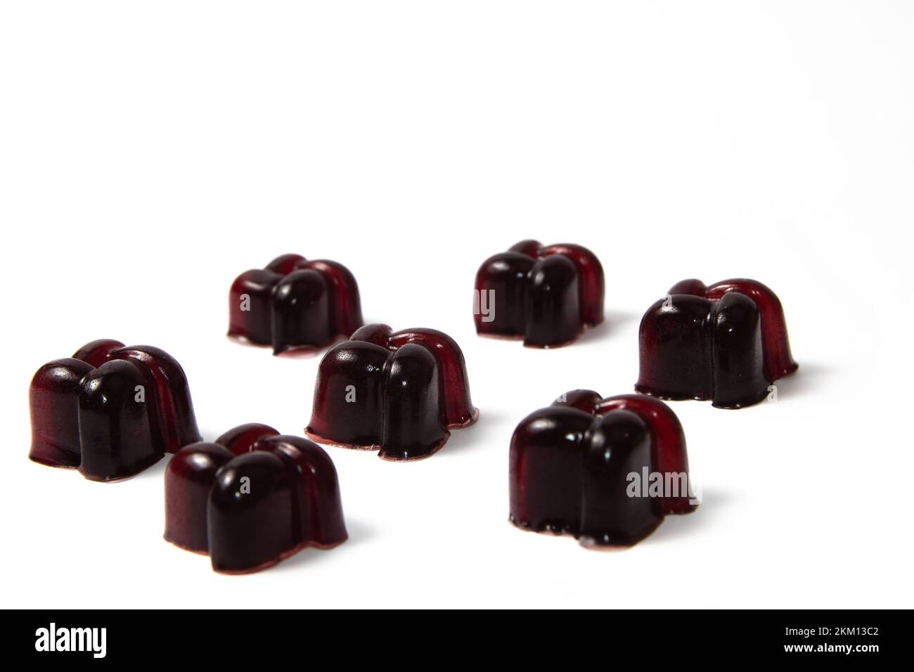 Dark red cherry homemade gelatin candy on white background Stock Photo ...