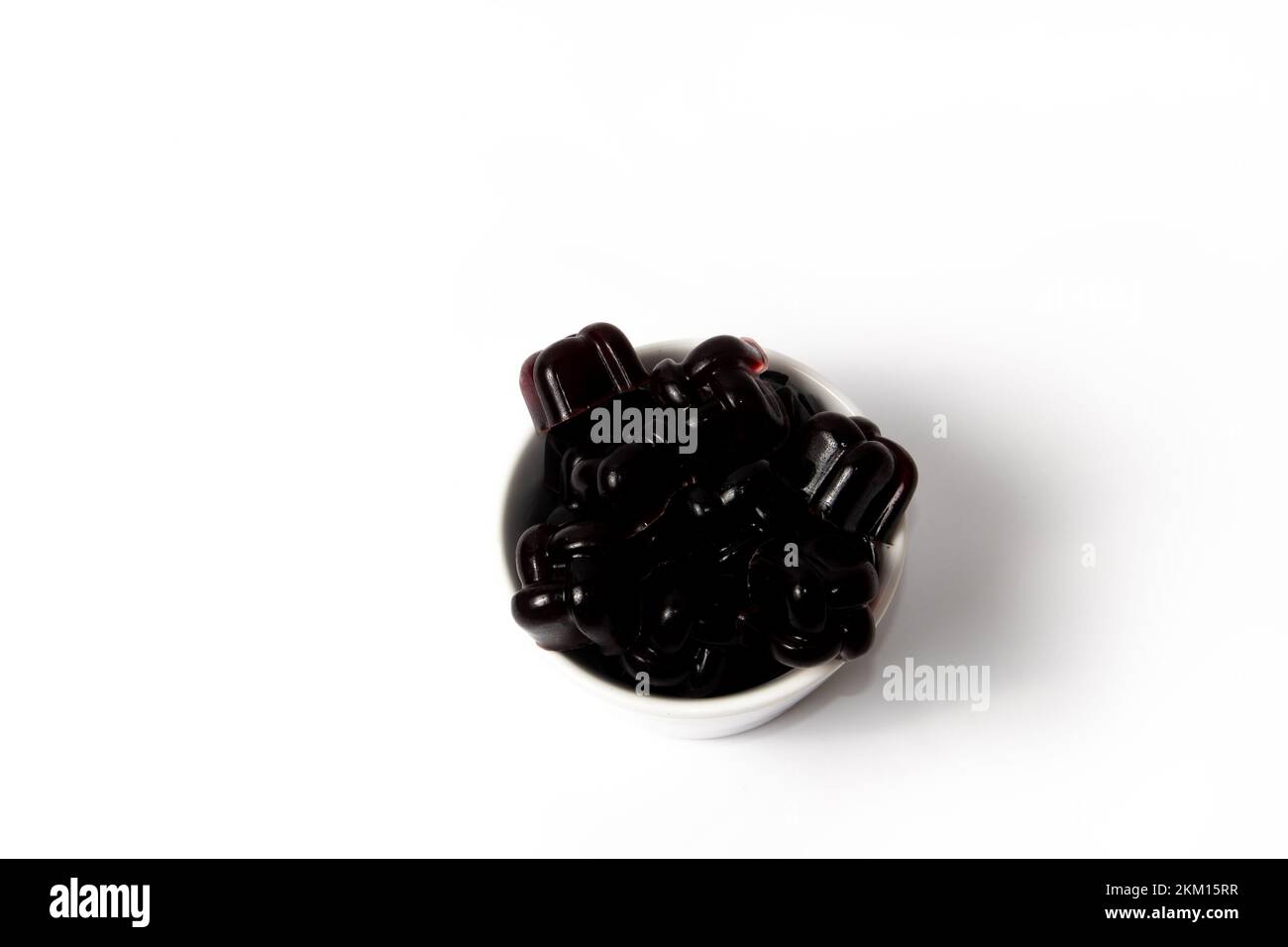 Homemade cherry gelatin candy in a white cup isolated Stock Photo - Alamy