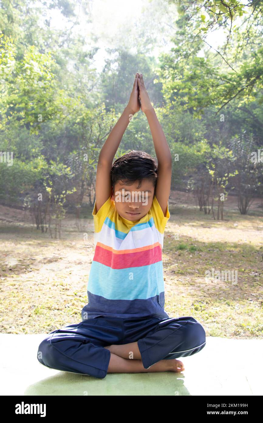 Young Boy doing yoga with hands in prayer position at outdoor Stock ...