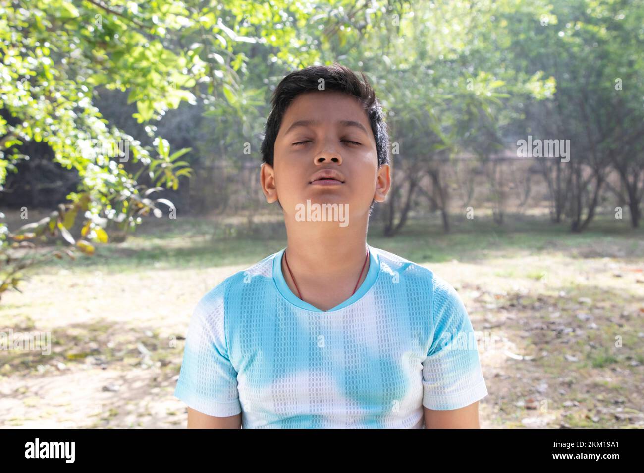 An indian boy doing yoga outdoors Stock Photo - Alamy