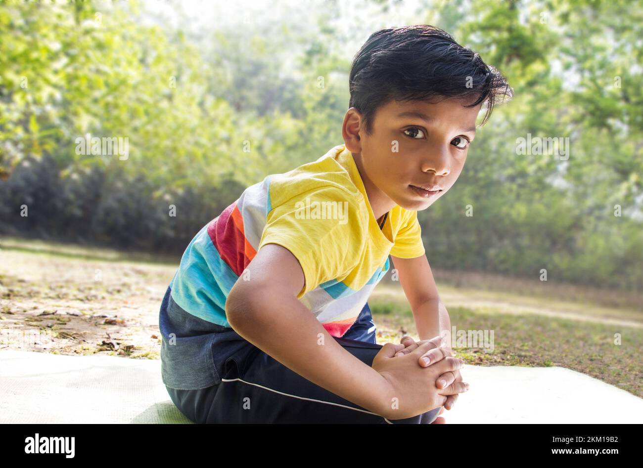 An indian boy doing yoga outdoors Stock Photo - Alamy