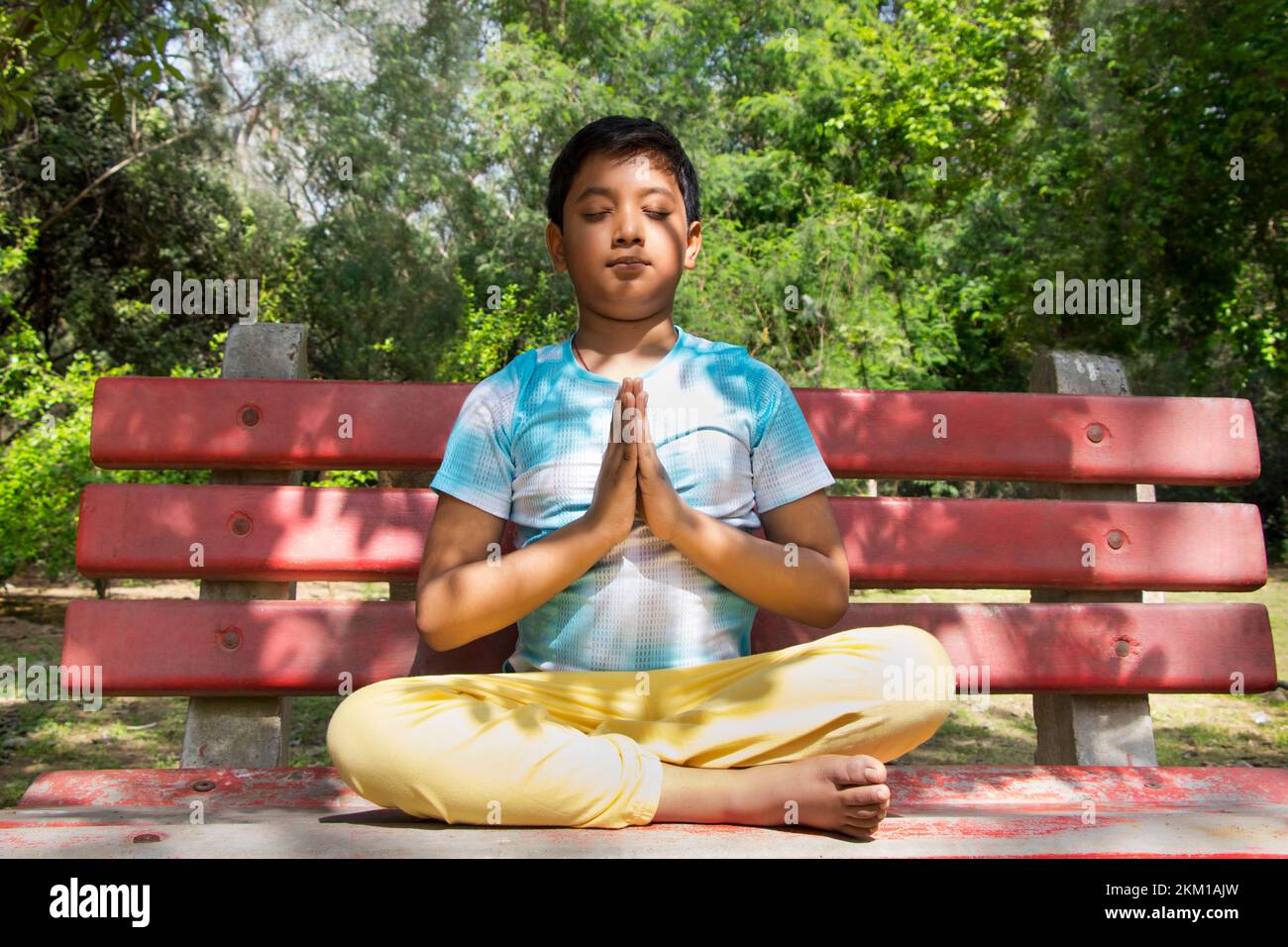 Indian Boy meditating in prayer position at park Stock Photo - Alamy