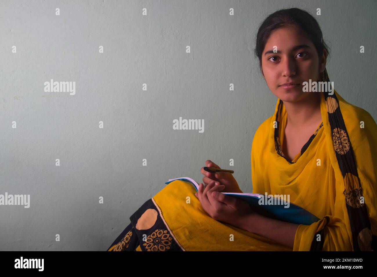 Indian teenage girl writing in notebook at home Stock Photo - Alamy