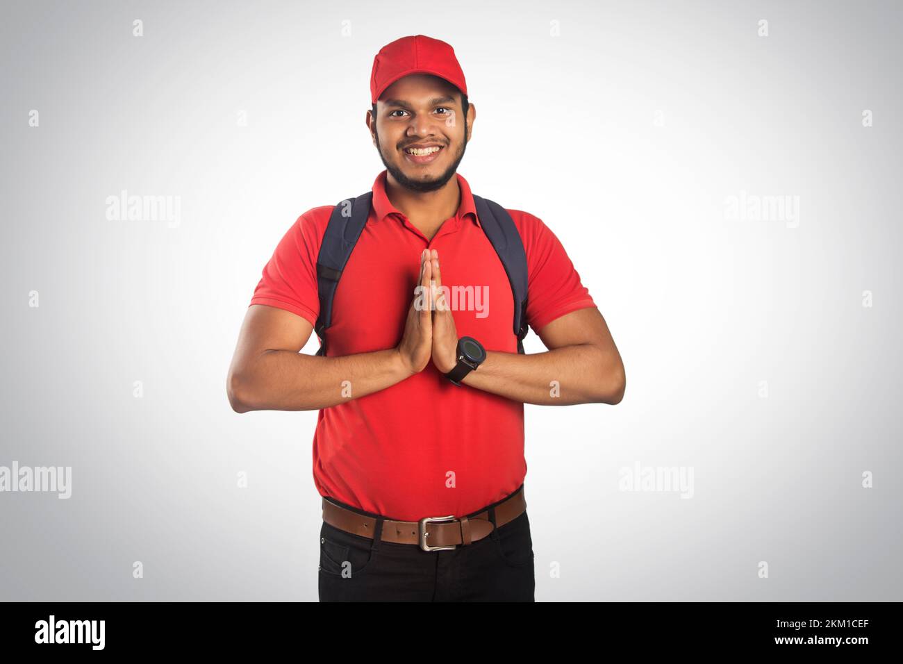 Young delivery boy with a bag pack greeting with a smile Stock Photo ...