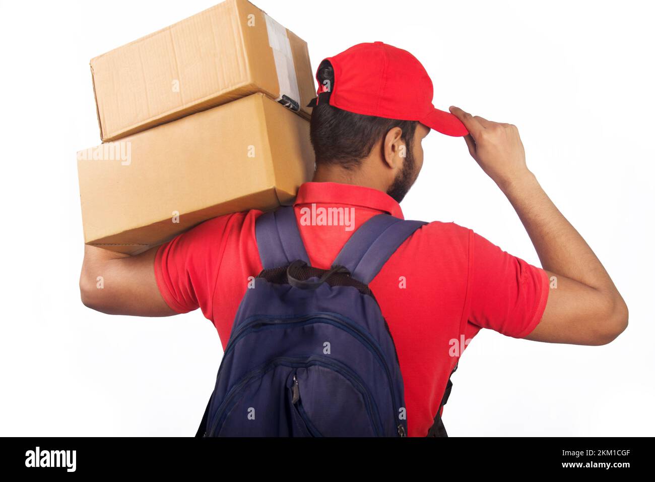 Back view Portrait Of Young Delivery Man Carrying Cardboard Box On ...
