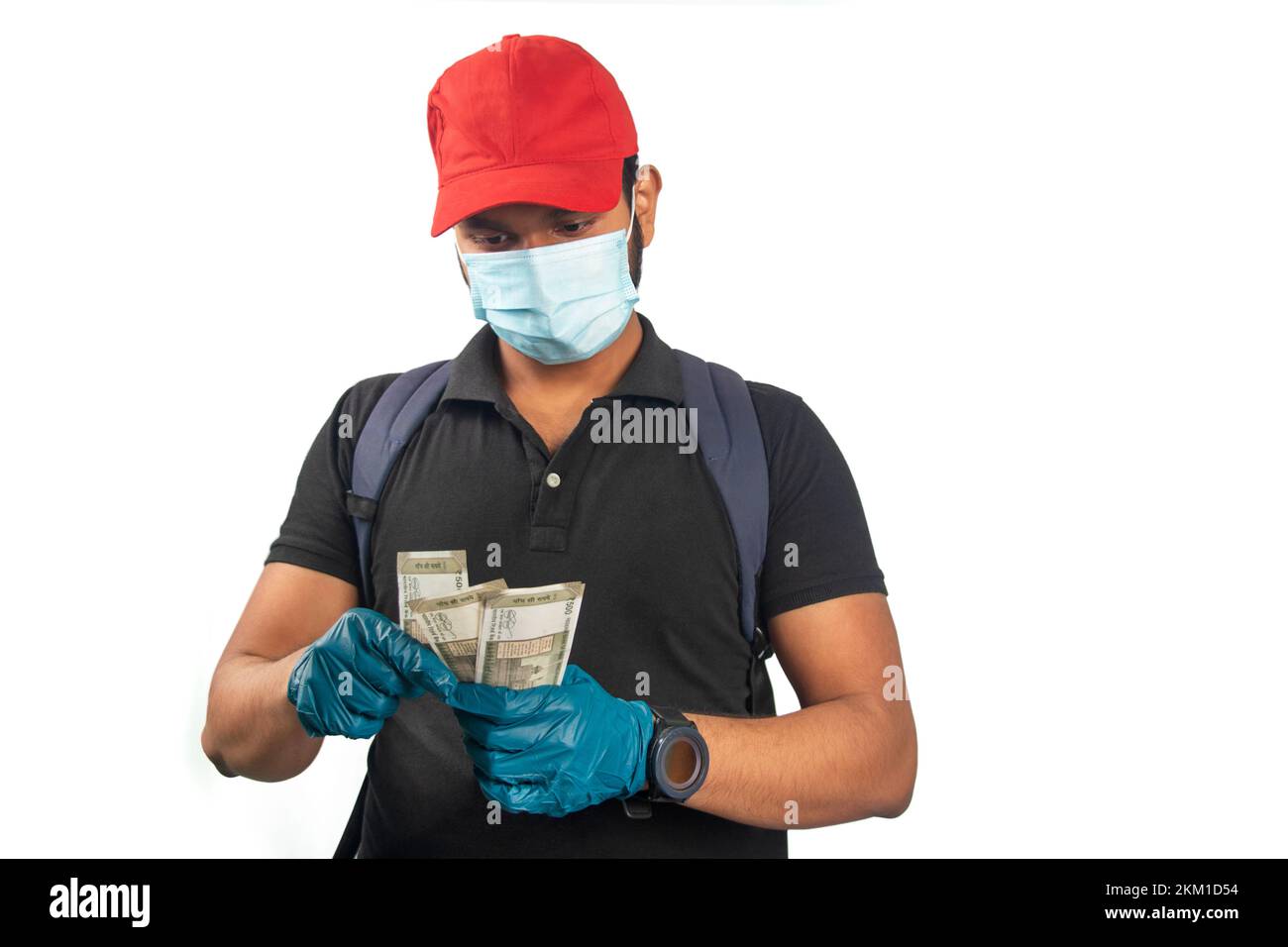 Delivery man receiving money from customer against Plain background ...