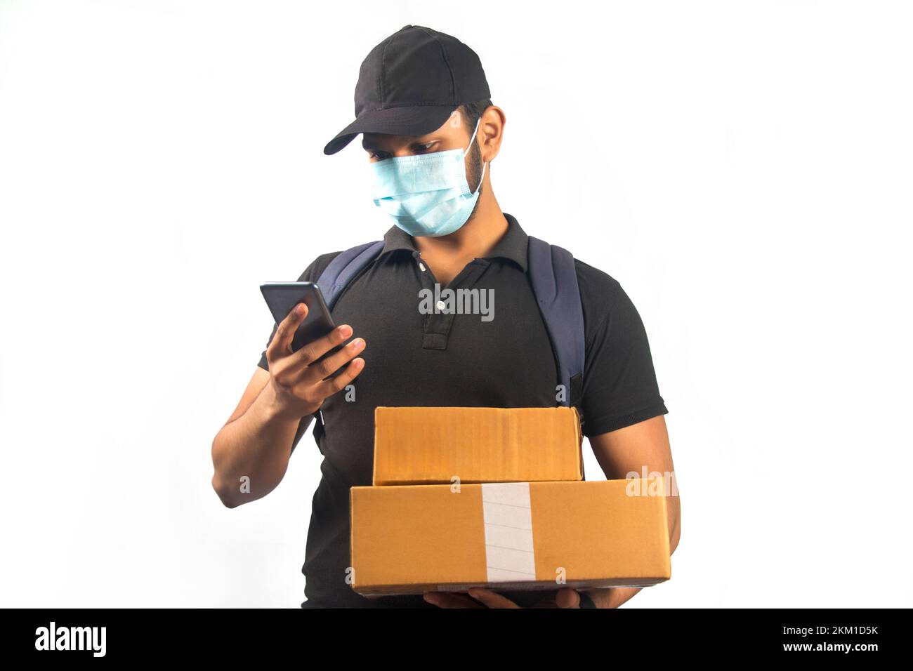 happy indian delivery man with smartphone and parcel box in Black ...