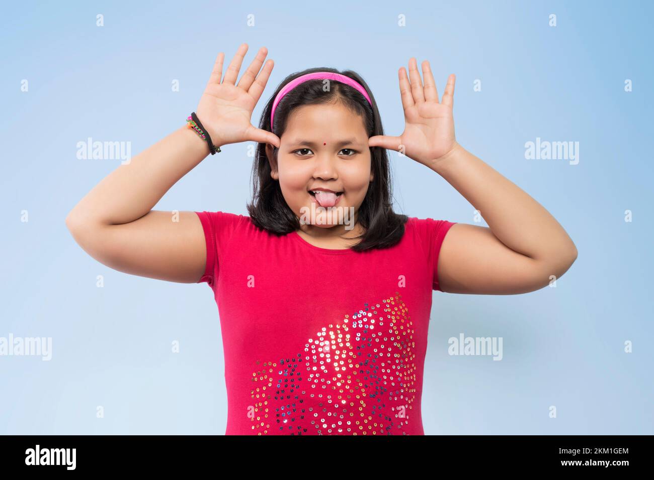 Portrait of girl making a teasing face Stock Photo - Alamy