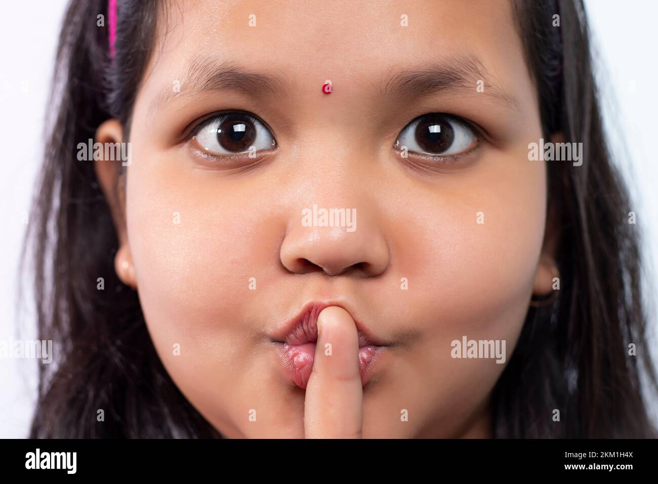 Finger on lips india hi-res stock photography and images - Alamy