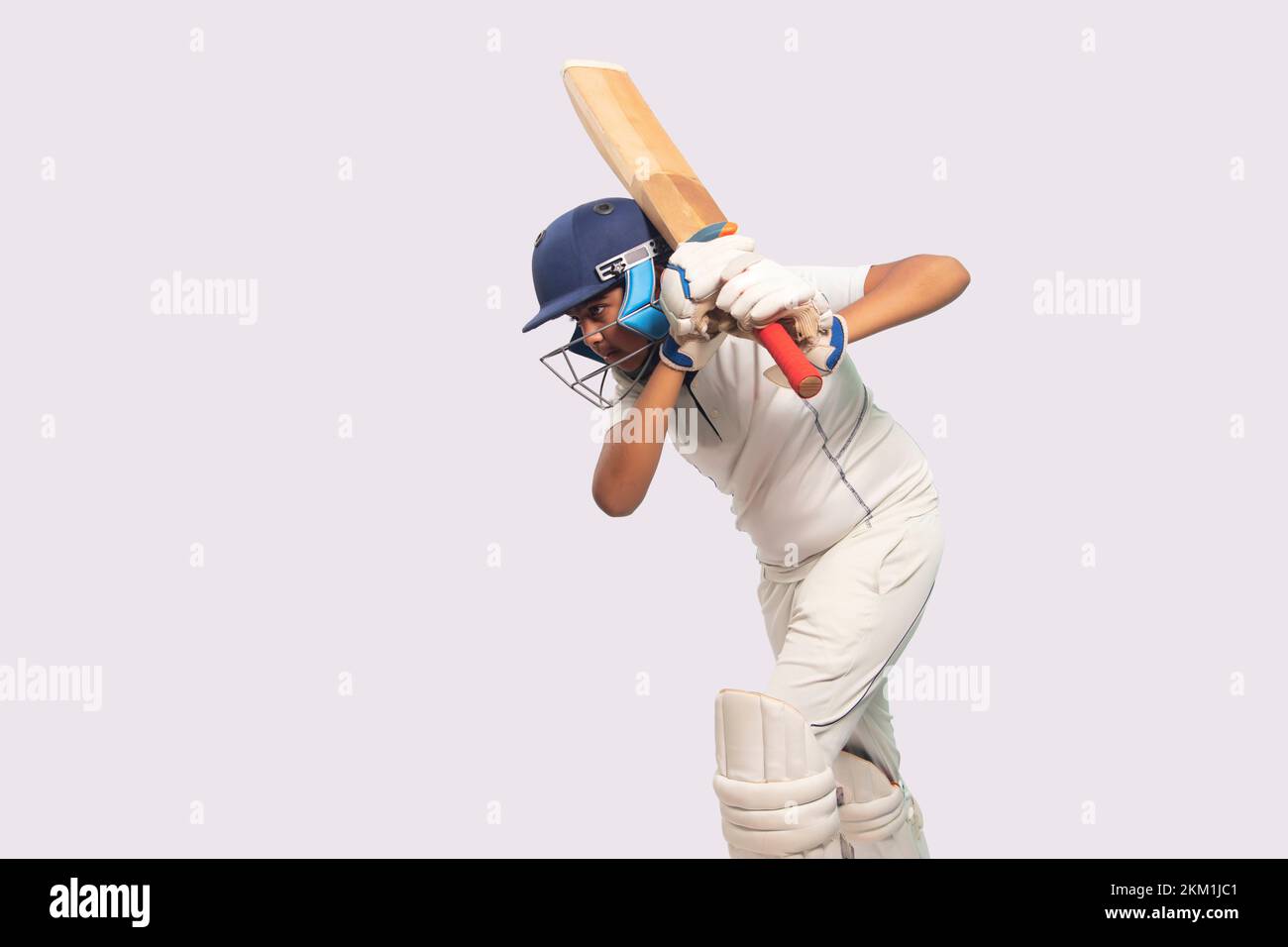 A boy in cricket uniform playing Cricket Stock Photo - Alamy
