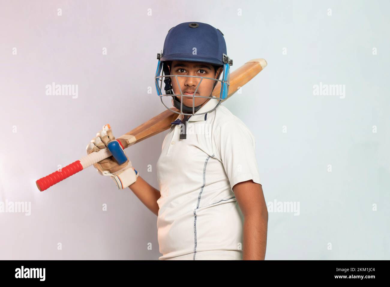 Portrait of boy wearing cricket Helmet and holding Bat Stock Photo - Alamy