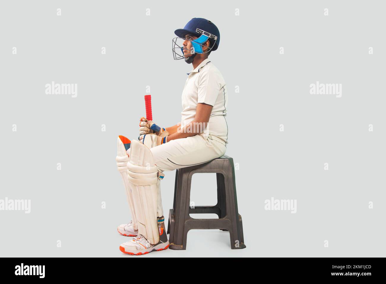 Portrait of young Indian sitting on the table and getting ready for ...