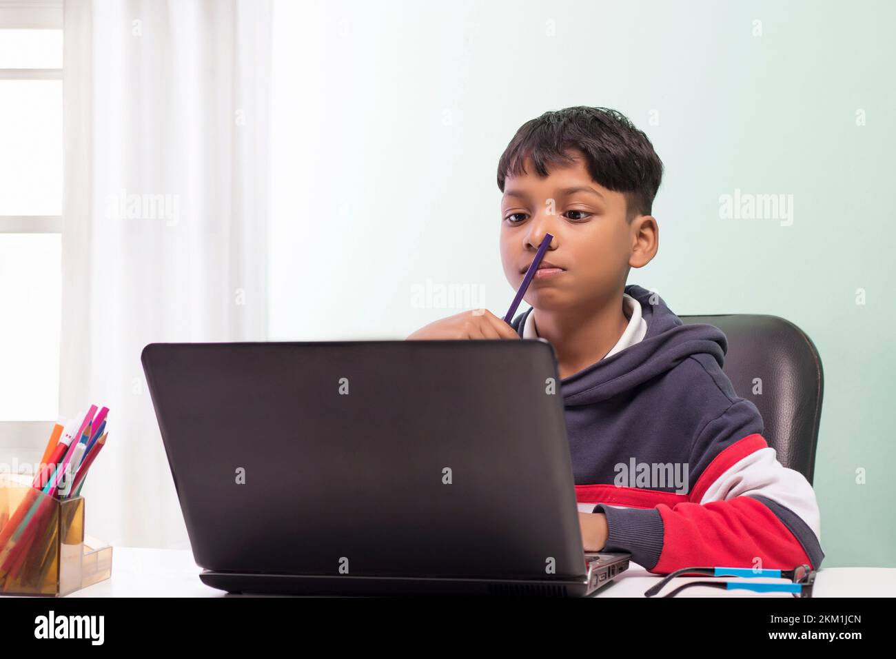 Indian kid doing homework computer hi-res stock photography and images ...