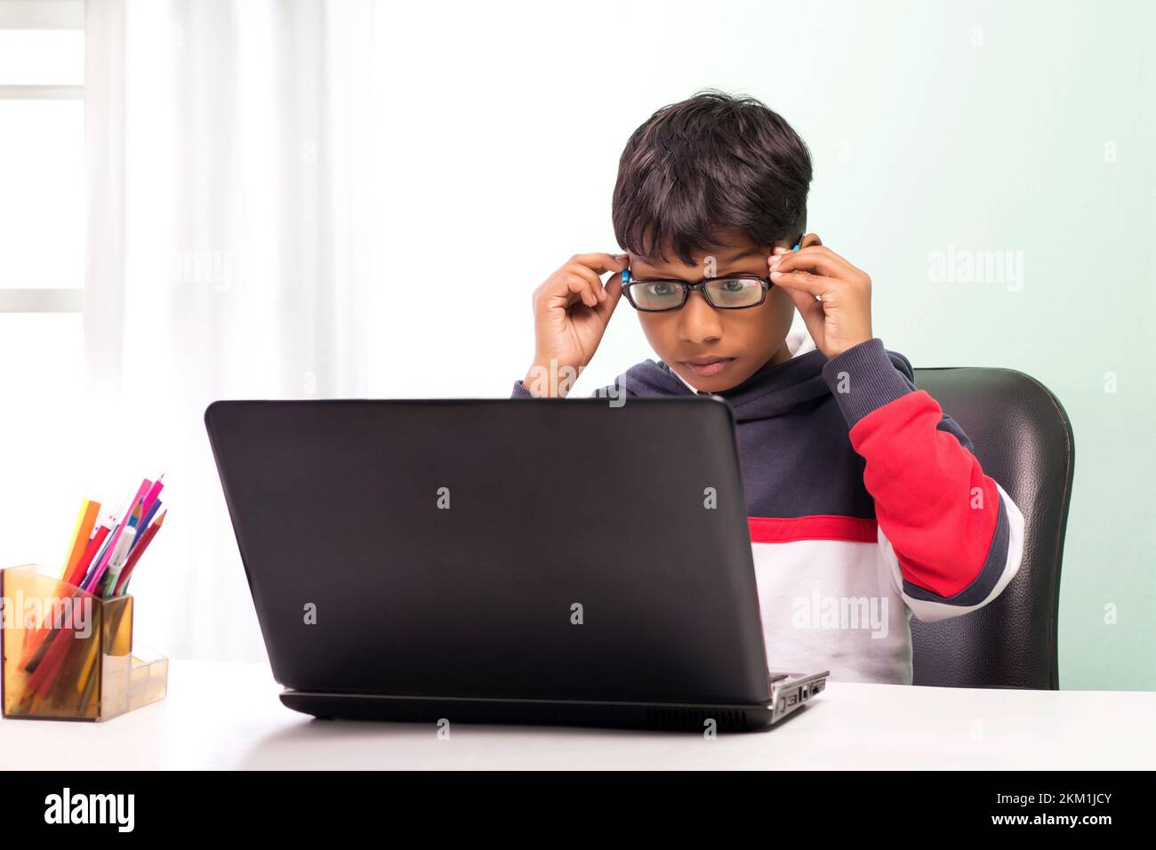 Indian kid doing homework computer hi-res stock photography and images ...