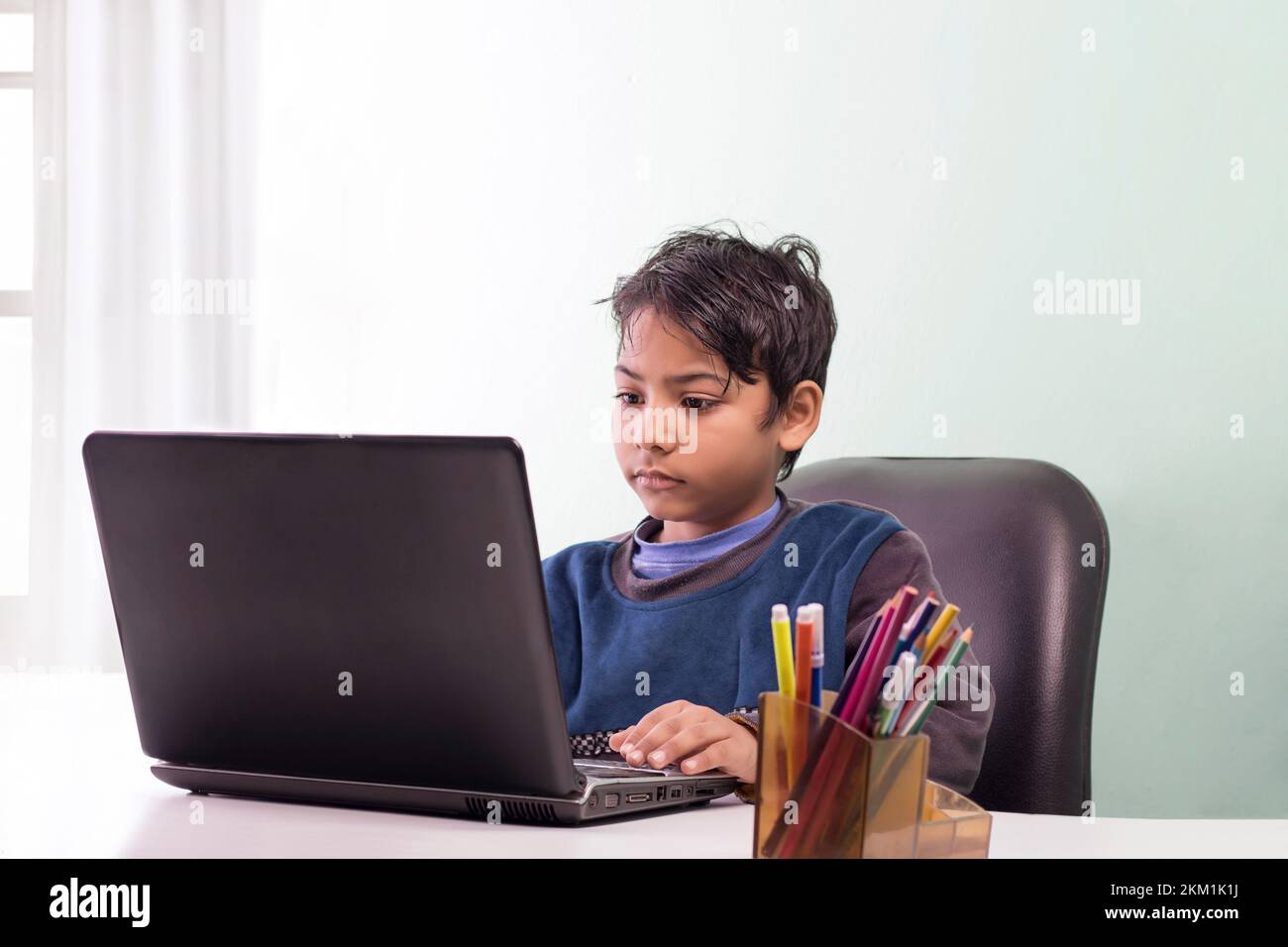 Indian kid doing homework computer hi-res stock photography and images ...