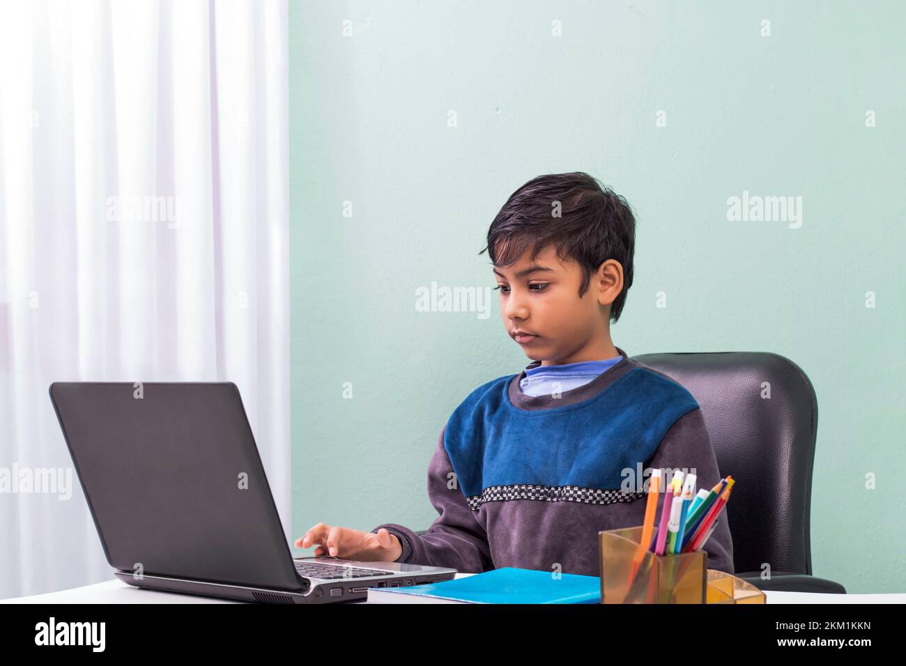 Little boys attending to online class from home. The school has been ...