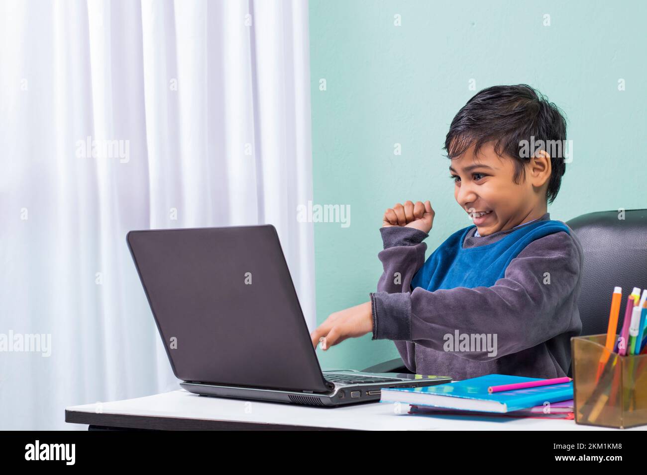 Little boys attending to online class from home. The school has been ...