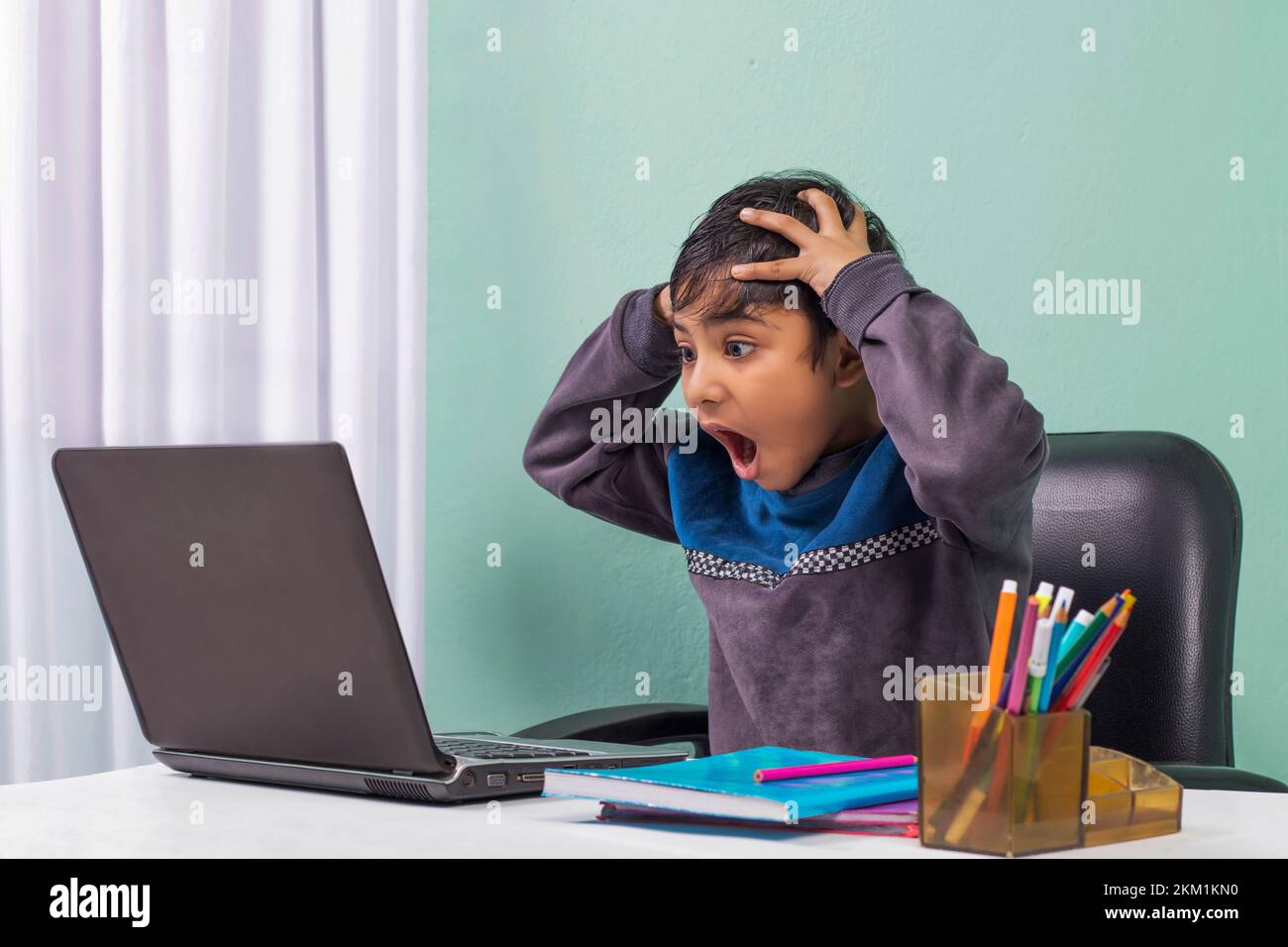 Shocked and surprised boy on the internet with laptop computer Stock ...