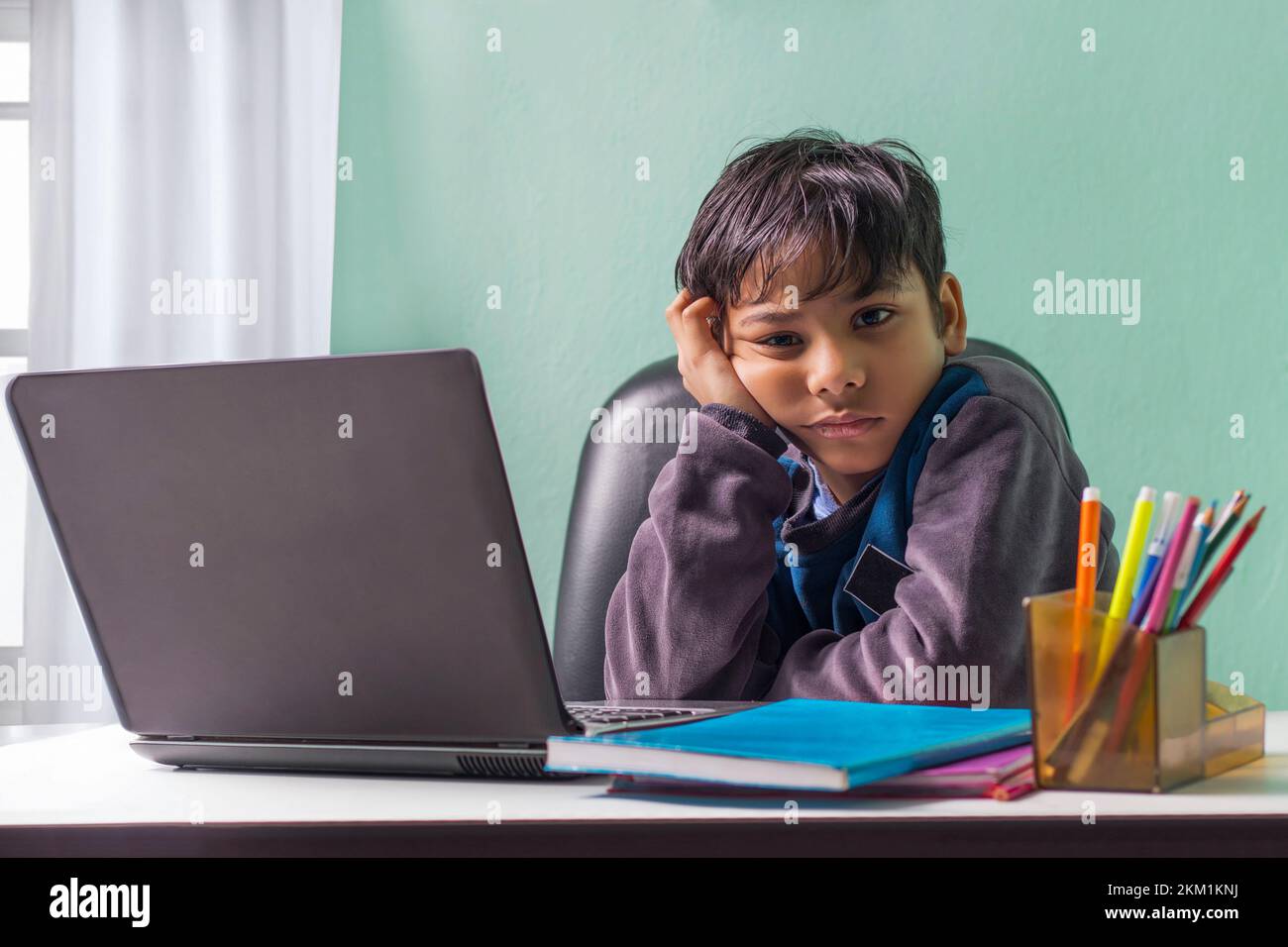 Little boys attending to online class from home. The school has been ...