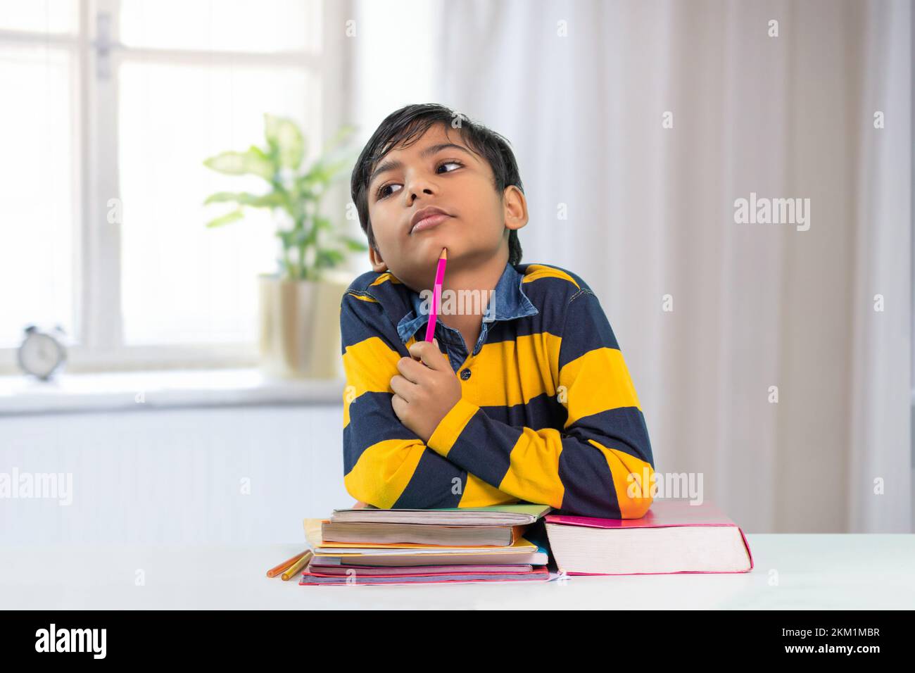 Indian school student sitting on table hi-res stock photography and ...