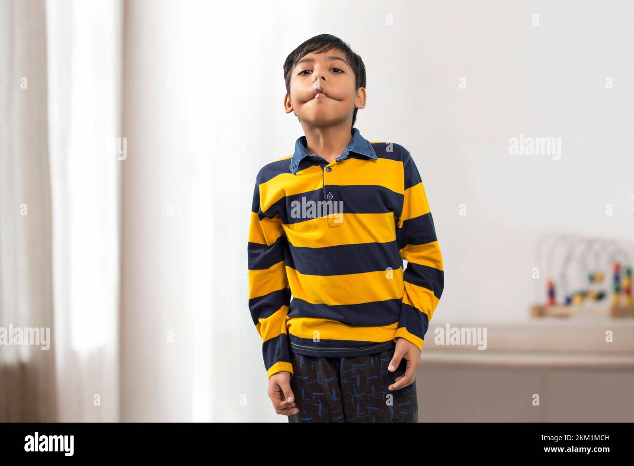 Portrait of indian boy making fish face with pout lips and looking ...