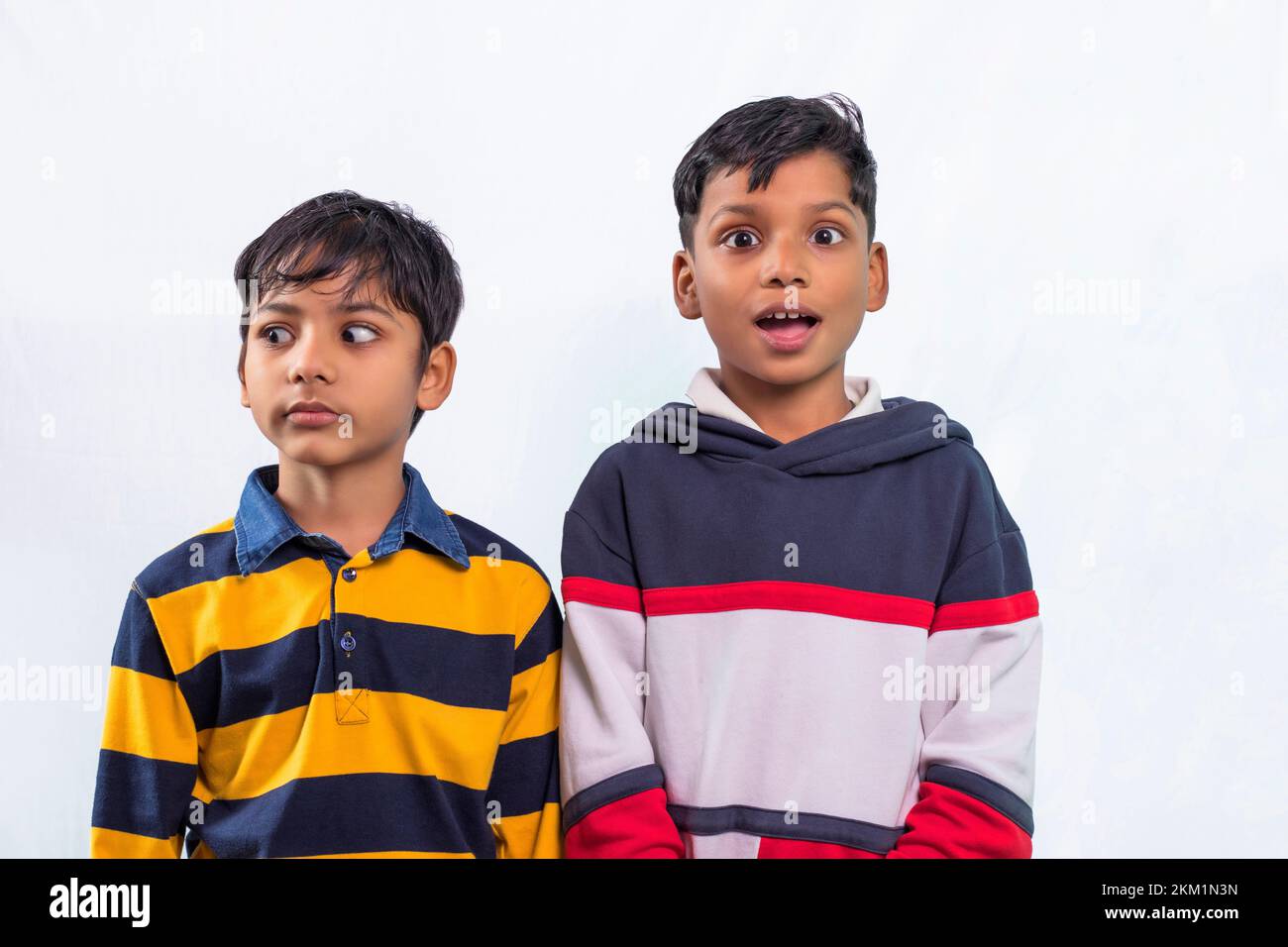 Two boys standing close Serious with excitement Stock Photo - Alamy