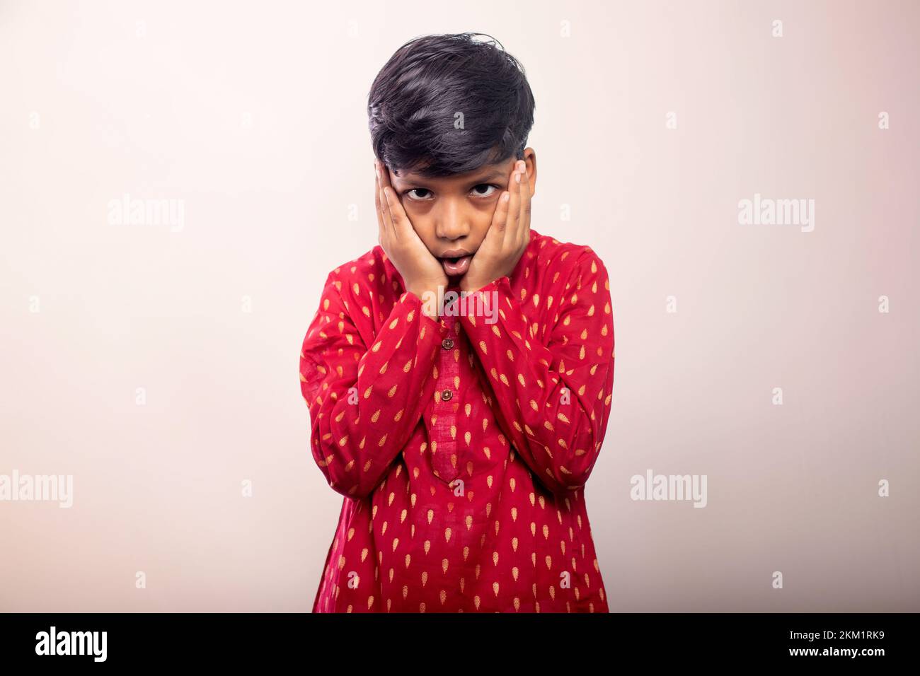 Boy wearing a traditional dress pressing cheeks Stock Photo - Alamy