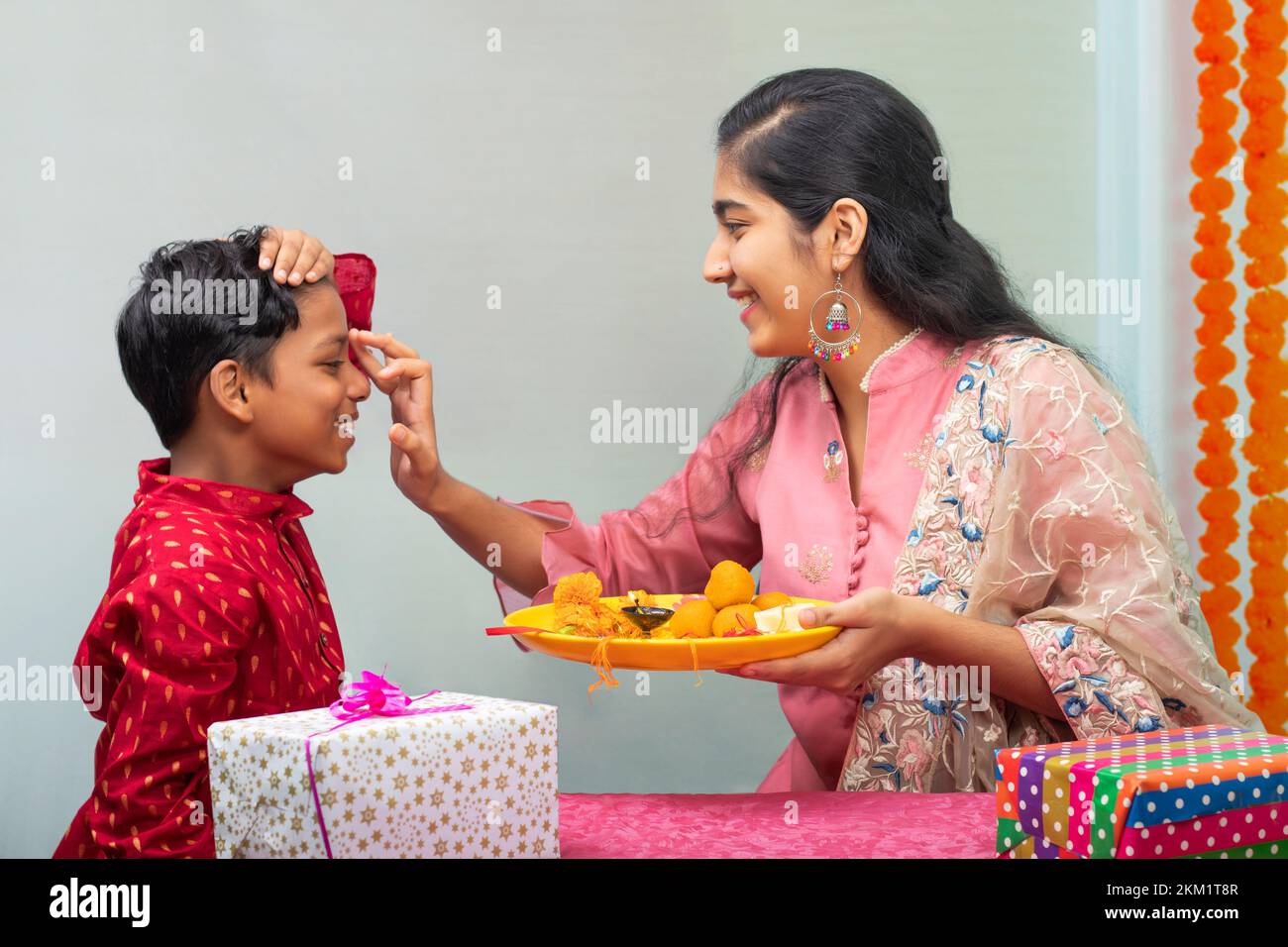 Sister applying tika on her brother's forehead on the occasion of ...