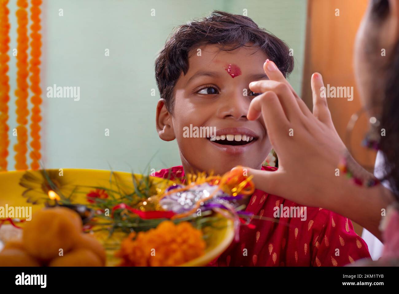 Sister applying tika on her brother's forehead on the occasion of ...