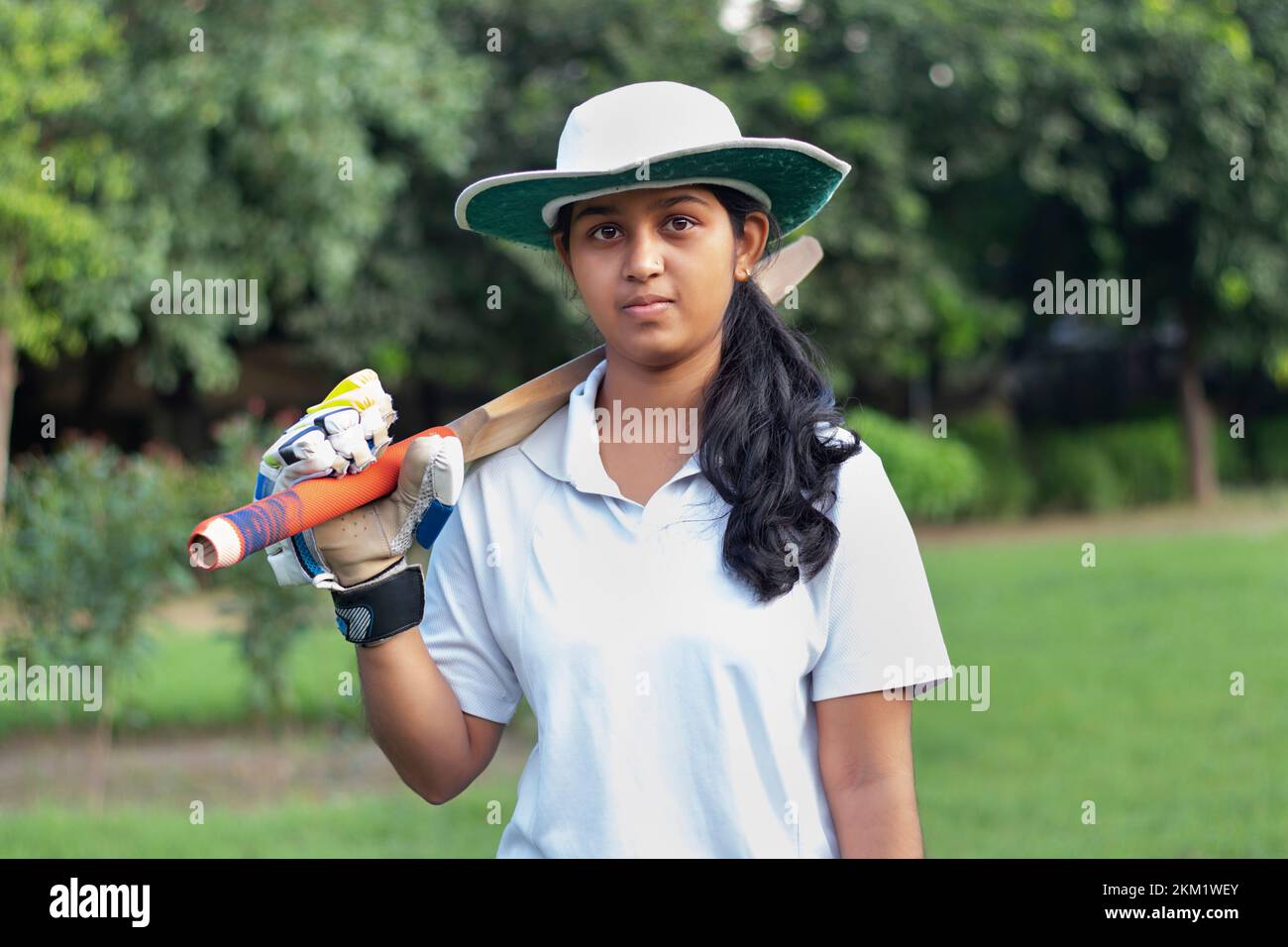 Portrait Of A Female Cricketer Holding A Cricket Bat Stock Photo - Alamy