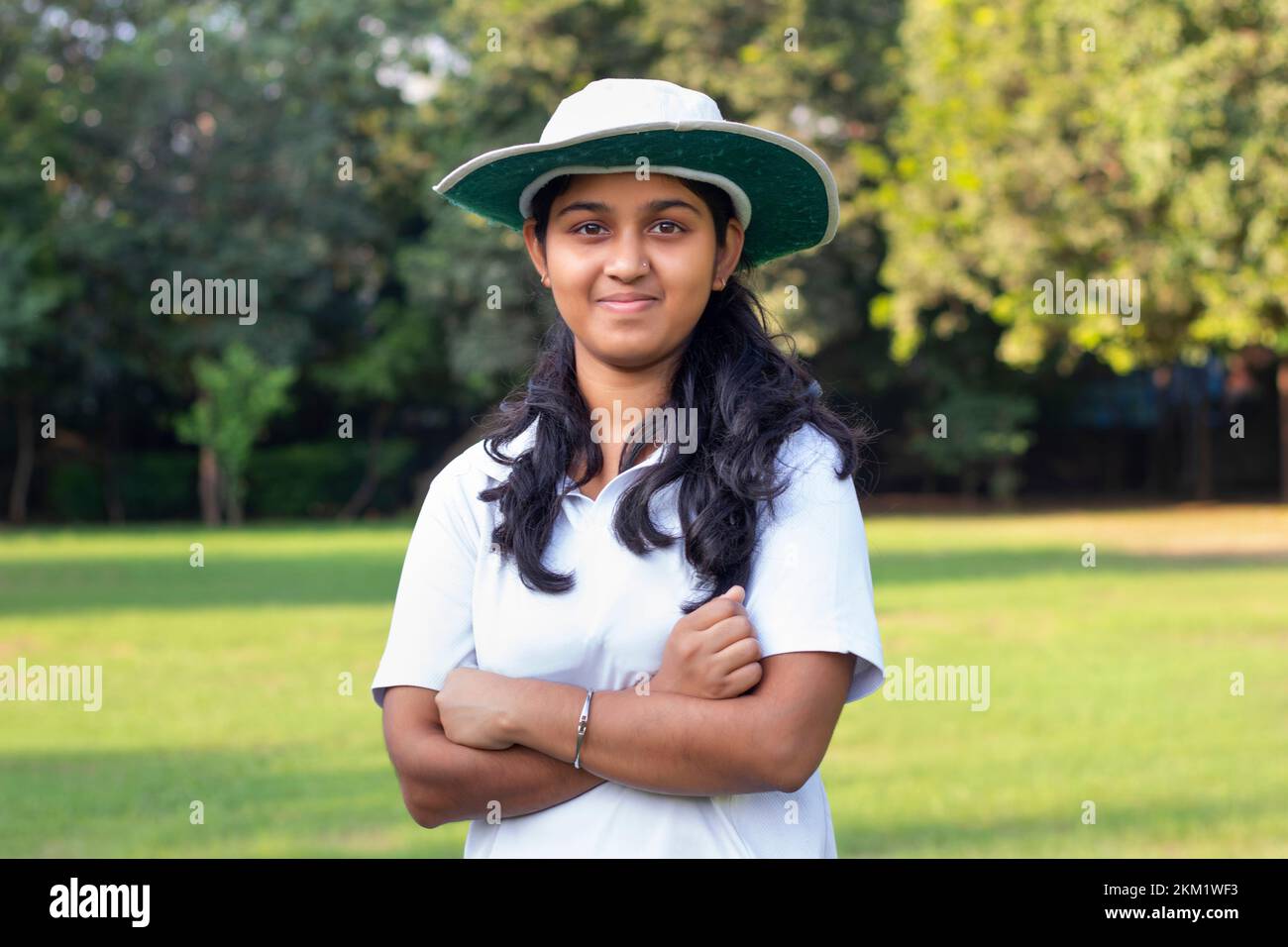 a girl wearing cricket uniform and cap standing in outdoor Stock Photo ...