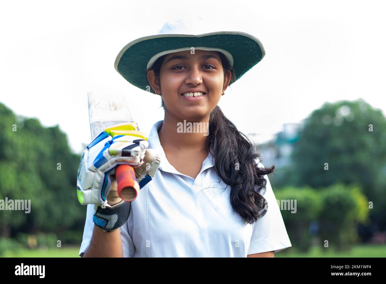 Portrait Of A Female Cricketer Holding A Cricket Bat Stock Photo - Alamy