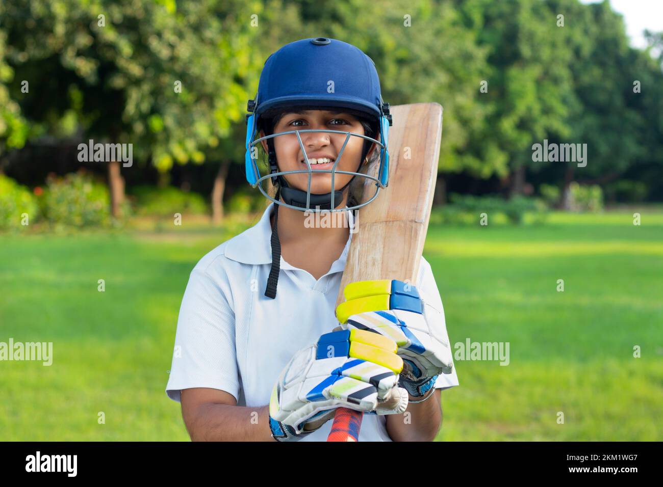 Portrait Of A Female Cricketer Holding A Cricket Bat Stock Photo - Alamy