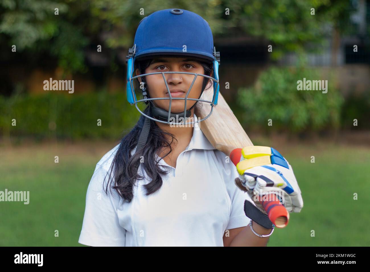Portrait Of A Female Cricketer Holding A Cricket Bat Stock Photo - Alamy